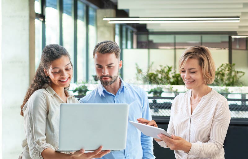 Three Business People Discussing Work Together Using a Tablet in a Modern Office Stock Image ...