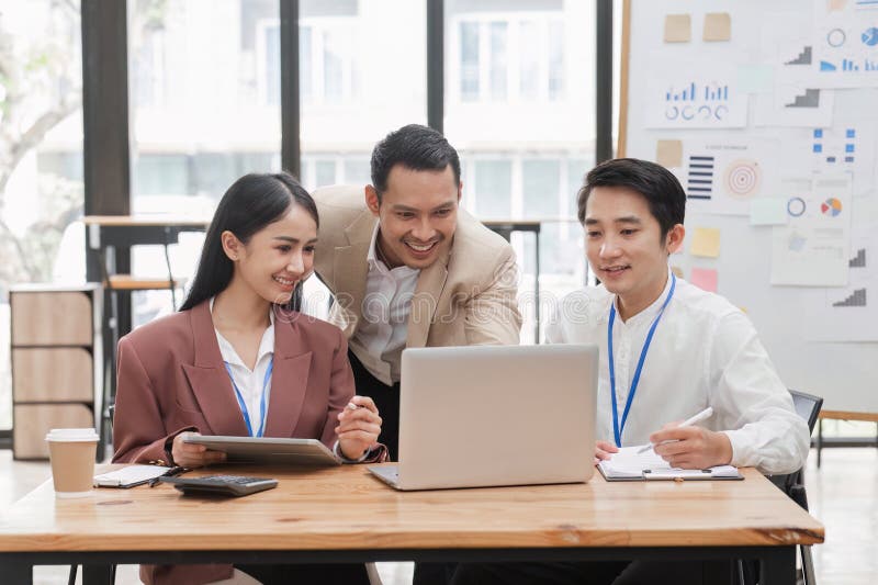 Three Business People are Enjoying Teamwork and Sharing Work Ideas ...