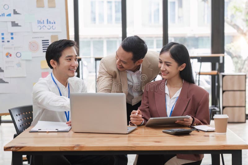 Three Business People are Enjoying Teamwork and Sharing Work Ideas ...