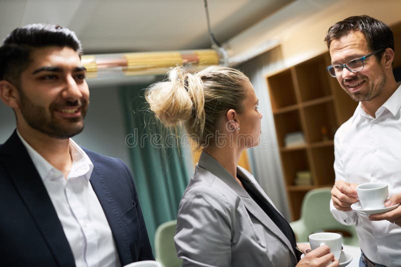 Three Business People Having Small Talk during the Break in the Office ...