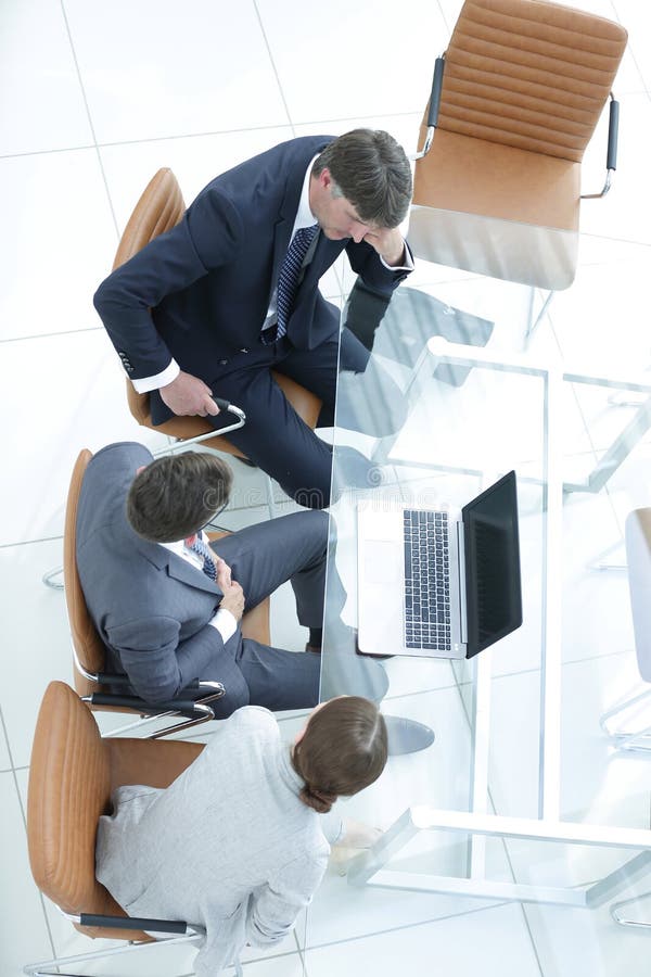 Three Business People, Meeting Around a Boardroom Table Stock Image ...