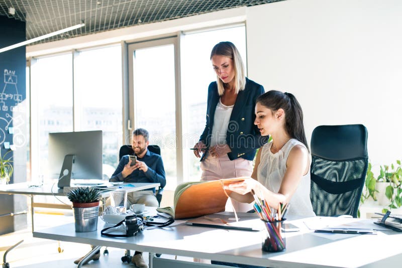 Three Business People in the Office Working Together. Stock Image ...