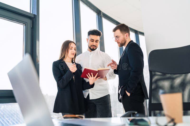 Three Business People are Standing in the Office. Stock Image - Image ...