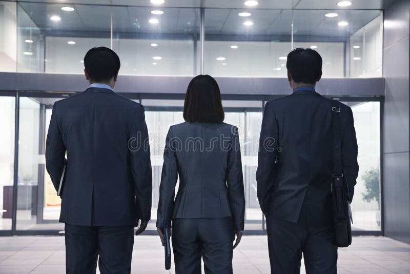 Three Business People Standing in a Row, Rear View Stock Photo - Image ...