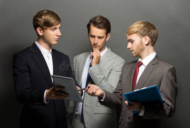 Three Businessman Discussing Plans at Office Stock Photo - Image of ...