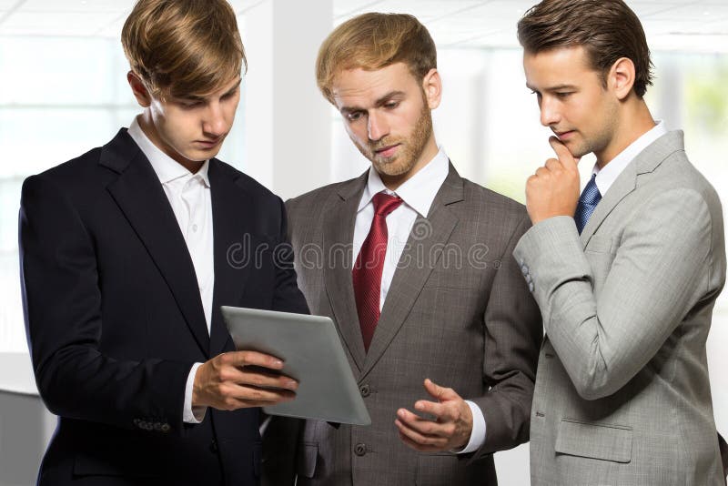 Three Businessman Discussing Plans at Office Stock Photo - Image of ...