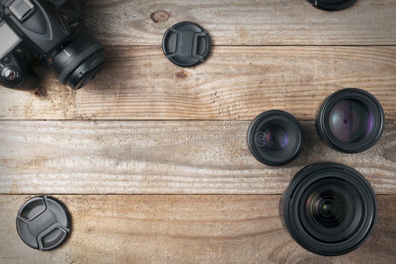 Three Camera Lenses and a Dslr Digital Camera on a Wooden Table, Top ...