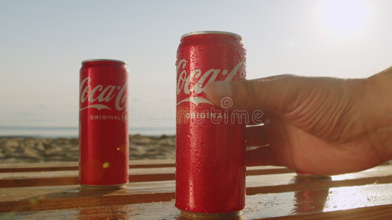 Three Cans of Cooling Coca Cola on the Beach at a Beautiful Sunset ...