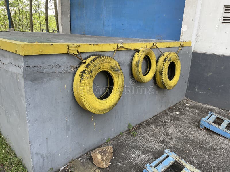 Three Car Tires Installed at the Loading Dock As a Safety Net. Stock ...