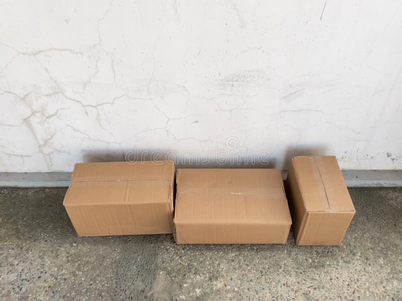 Three Cardboard Boxes Resting on a Grungy Concrete Surface Stock Image ...