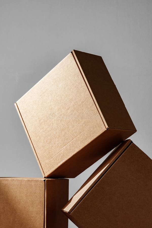 Three Cardboard Boxes Stacked on a Wooden Surface in a Room with ...