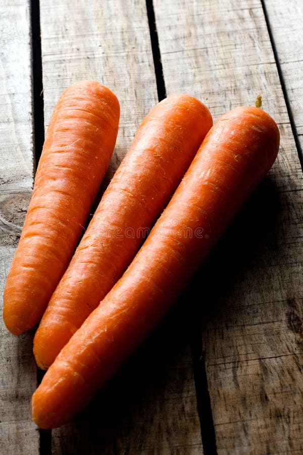 Three Carrots on White Plate Stock Photo - Image of light, dining: 14919708
