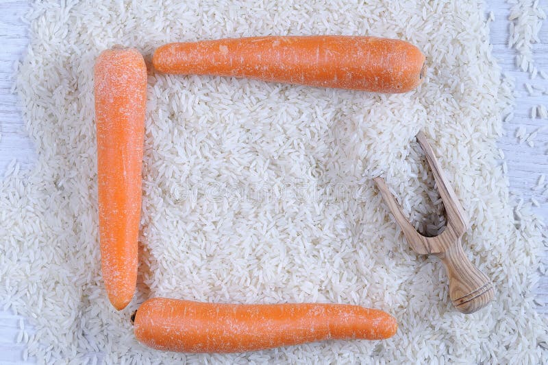 Three Carrots on Pile of White Rice Stock Image - Image of arranged ...