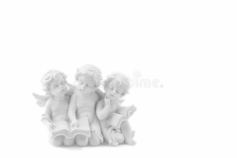 Three Ceramic White Angels Read the Book, Dreaming and Thinking. Stock ...