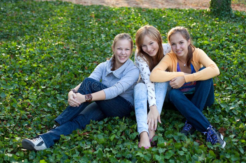 Three Cheerful Student Girls Stock Image - Image of nature, grass: 22706747