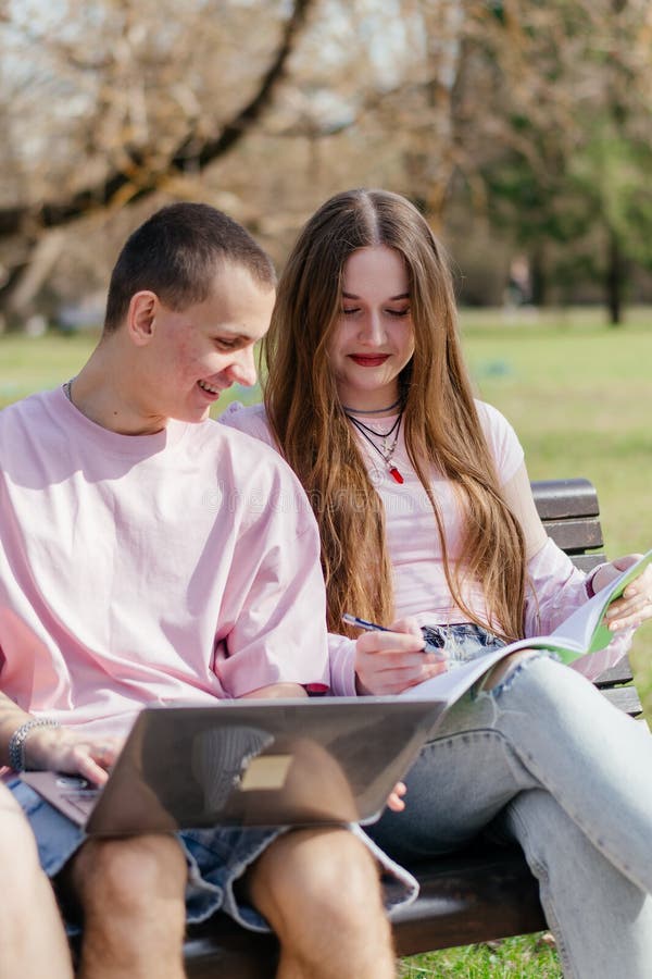 Three Cheerful Students Study and Work Together Outdoors on a Sunny Day ...