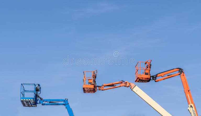 Three Cherry Picker Machines Stock Photo - Image of moving, steel ...