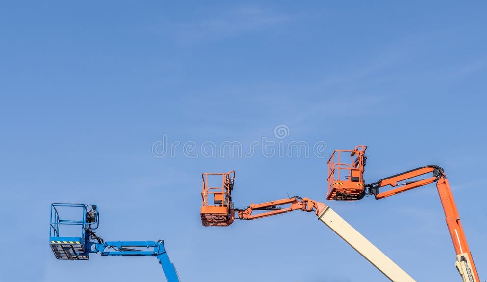 Three Cherry Picker Machines Stock Photo - Image of moving, steel ...