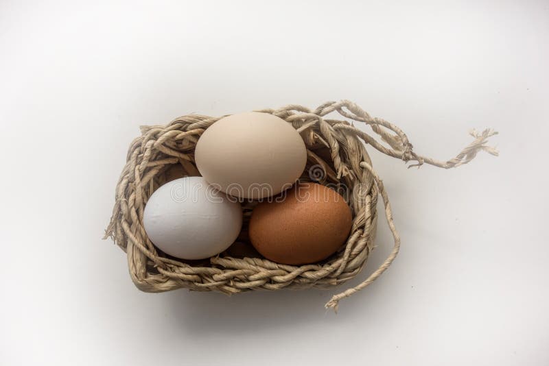 Three Chicken Eggs of Different Colors in a Wicker Basket Stock Image ...