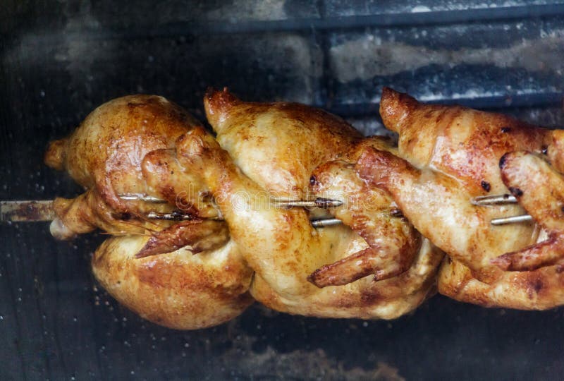 Chickens Roasting on Spit stock image. Image of meat - 114420075
