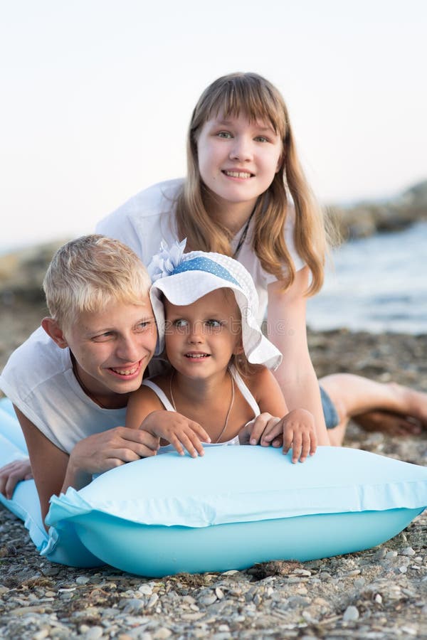Three Children on the Beach Stock Image - Image of group, family: 120998577