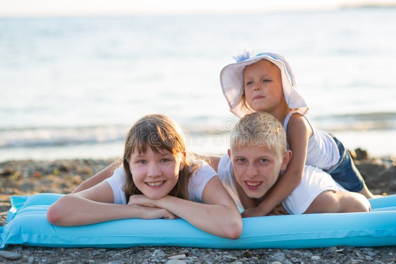 Three Children on the Beach Stock Image - Image of lifestyle, leisure ...
