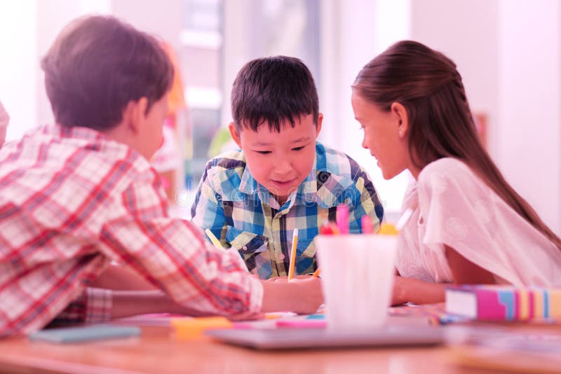 Thoughtful Children Dicsussing the Task in a Classroom Stock Image ...