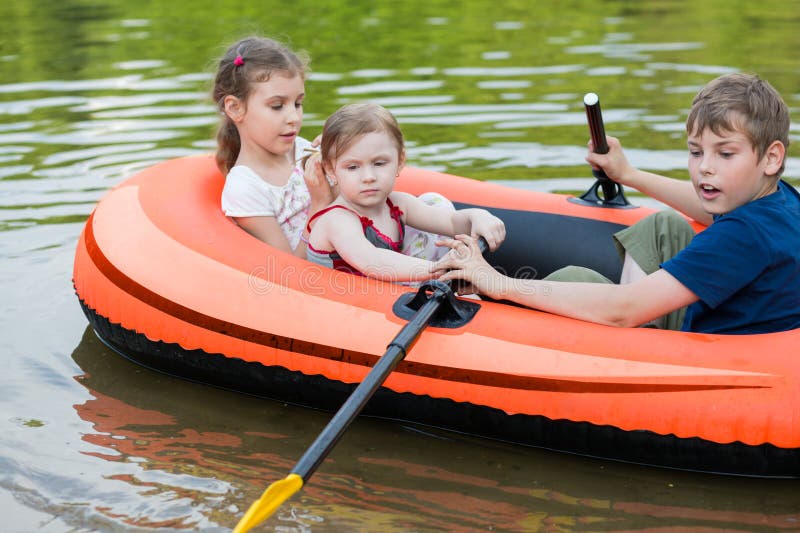 Three Children Floating in a Rubber Boat on the Stock Image - Image of ...