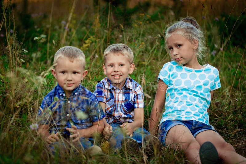 Three children on meadow stock image. Image of active - 49272581