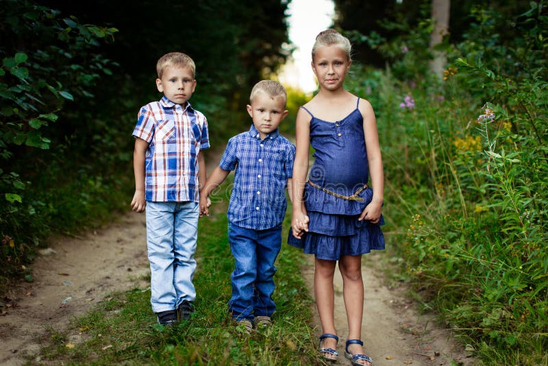 Three children on meadow stock image. Image of children - 49272609