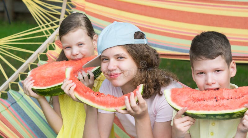 Three Children, Outdoors, Eat a Sweet Watermelon Stock Photo - Image of ...