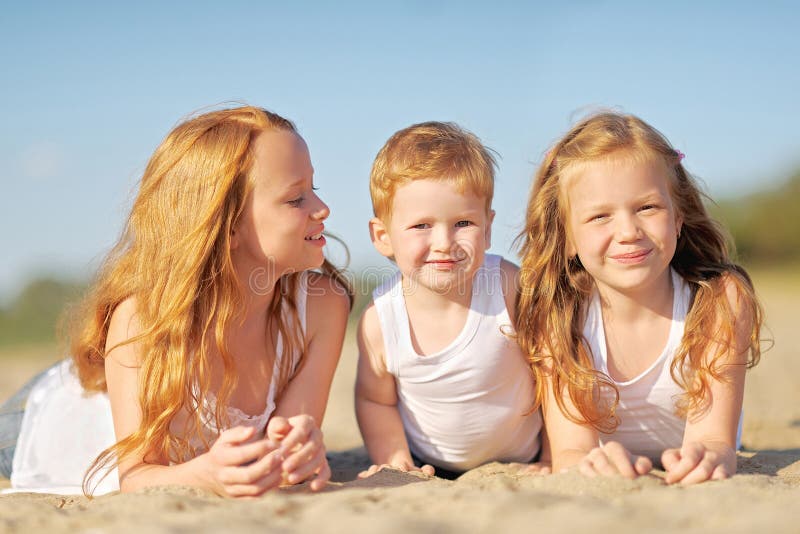 Three Children Playing on Beach Stock Image - Image of hair, gold: 48397747