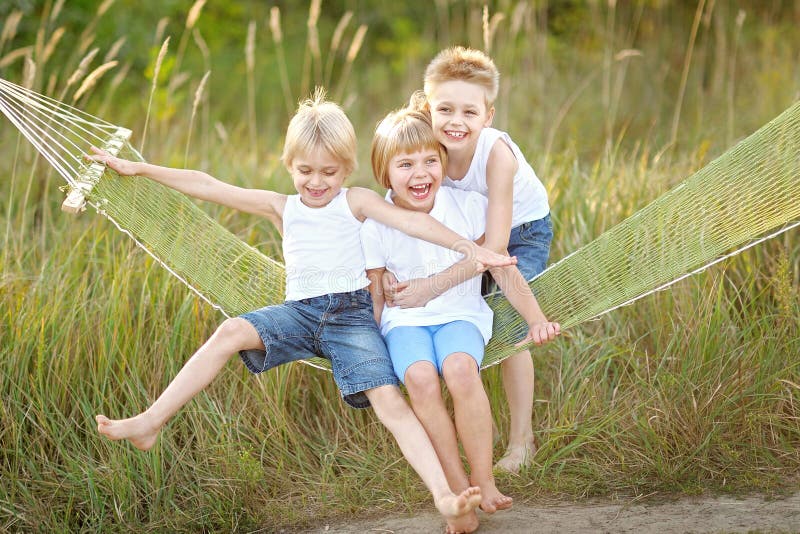 Three children playing stock photo. Image of black, hold - 48055712