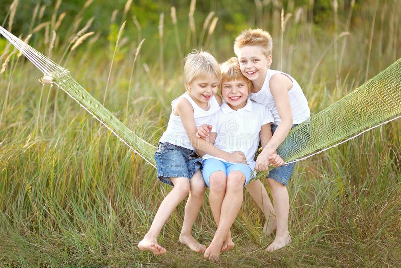 Three children playing stock photo. Image of holding - 48055720