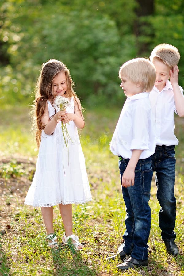 Three Children Playing on Meadow Stock Photo - Image of black, girl ...
