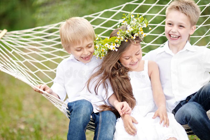 Three Children Playing on Meadow Stock Photo - Image of holding, girl ...