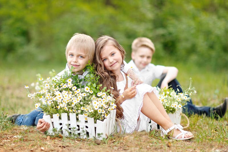 Three Children Playing on Meadow Stock Photo - Image of meadow, girl ...