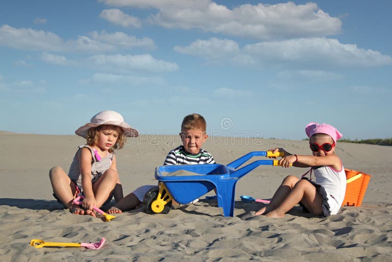 Three Children Playing in Sand Stock Image - Image of cloud, leisure ...