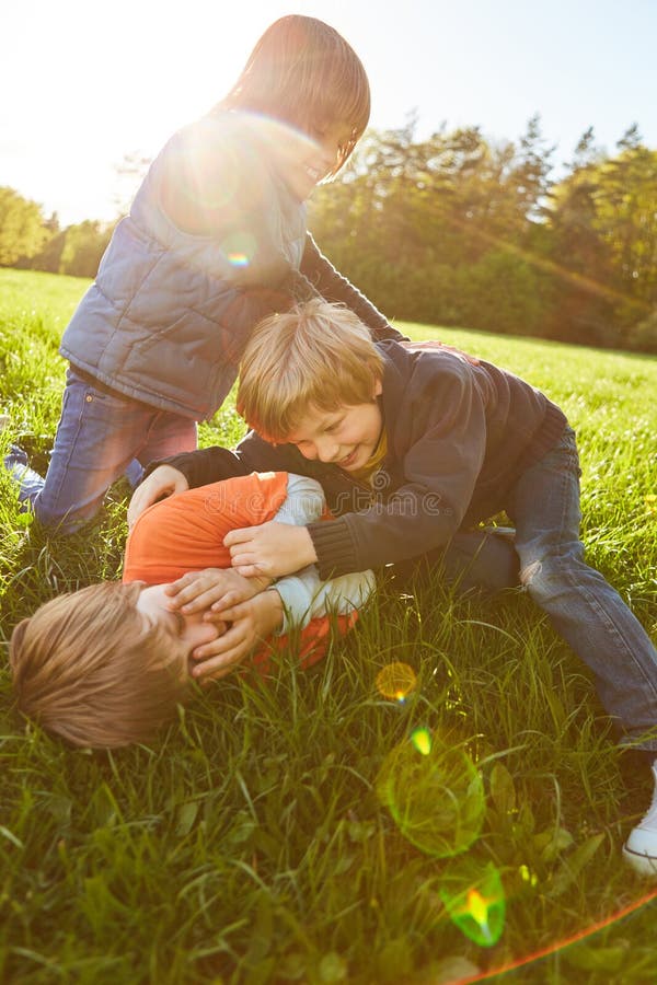 Three Children are Romping Around in a Meadow Stock Image - Image of ...