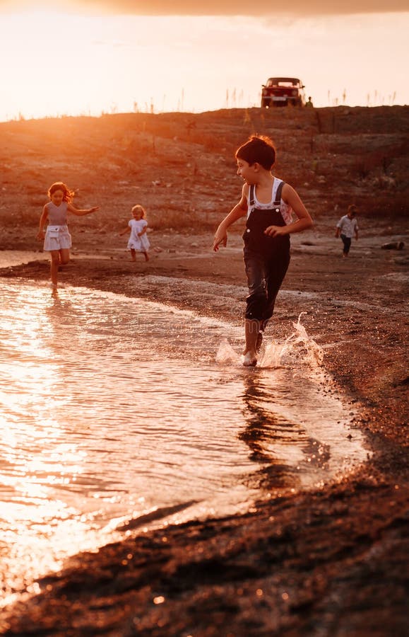 Three Children Running Along Beach Stock Photo - Image of girl, active ...