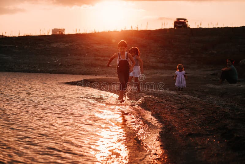 Three Children Running Along Beach Stock Image - Image of seaside ...