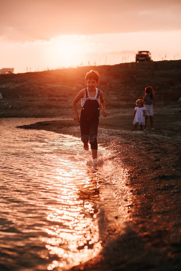 Three Children Running Along Beach Stock Image - Image of friendship ...