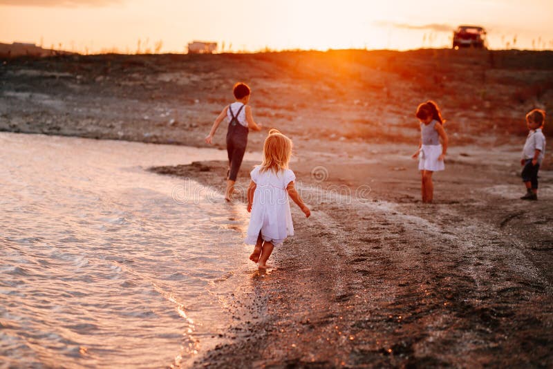 Three Children Running Along Beach Stock Photo - Image of group, child ...
