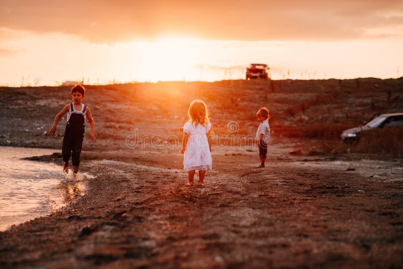 Three Children Running Along Beach Stock Photo - Image of friendship ...