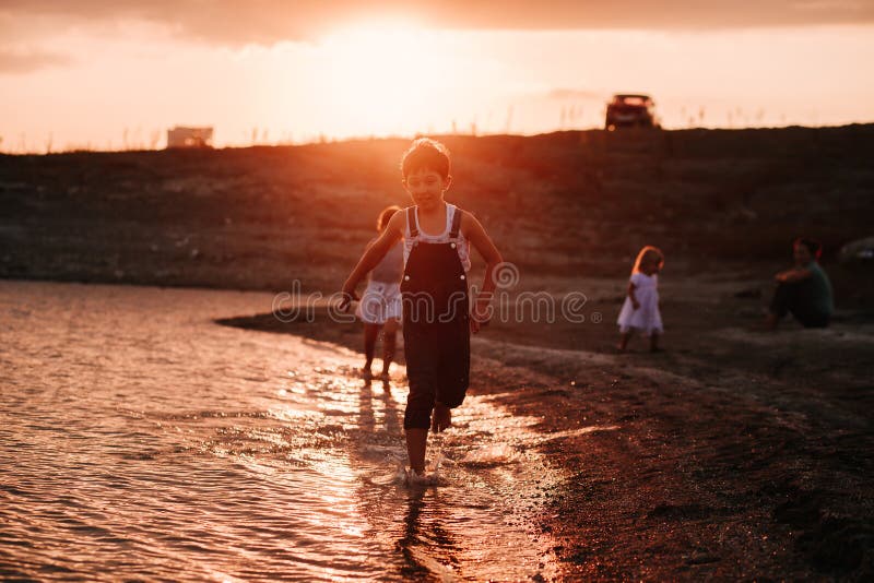 Three Children Running Along Beach Stock Image - Image of laughing ...