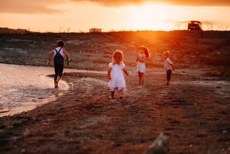Three Children Running Along Beach Stock Image - Image of happy, active ...