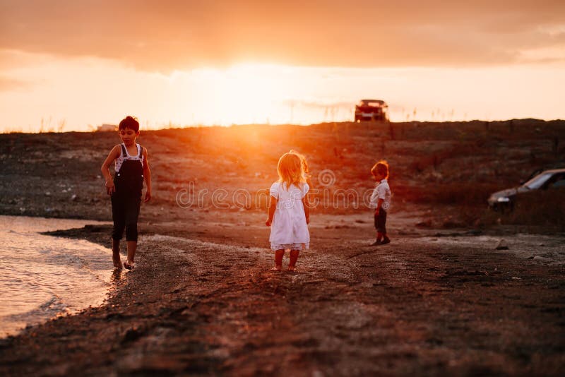 Three Children Running Along Beach Stock Photo - Image of shorts ...