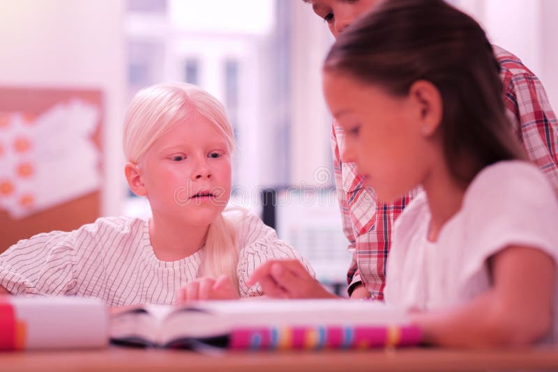 Thoughtful Children Dicsussing the Task in a Classroom Stock Image ...
