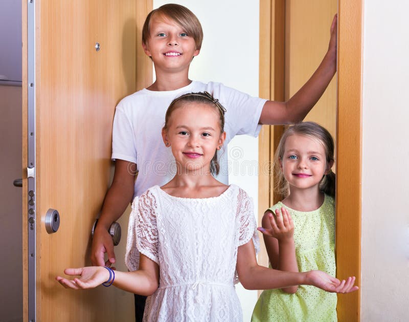 Three Children Standing at House Entrance Stock Photo - Image of ...