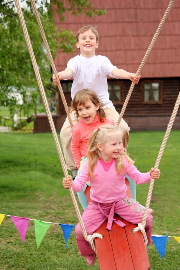Three children on swing stock photo. Image of board, child - 9873218